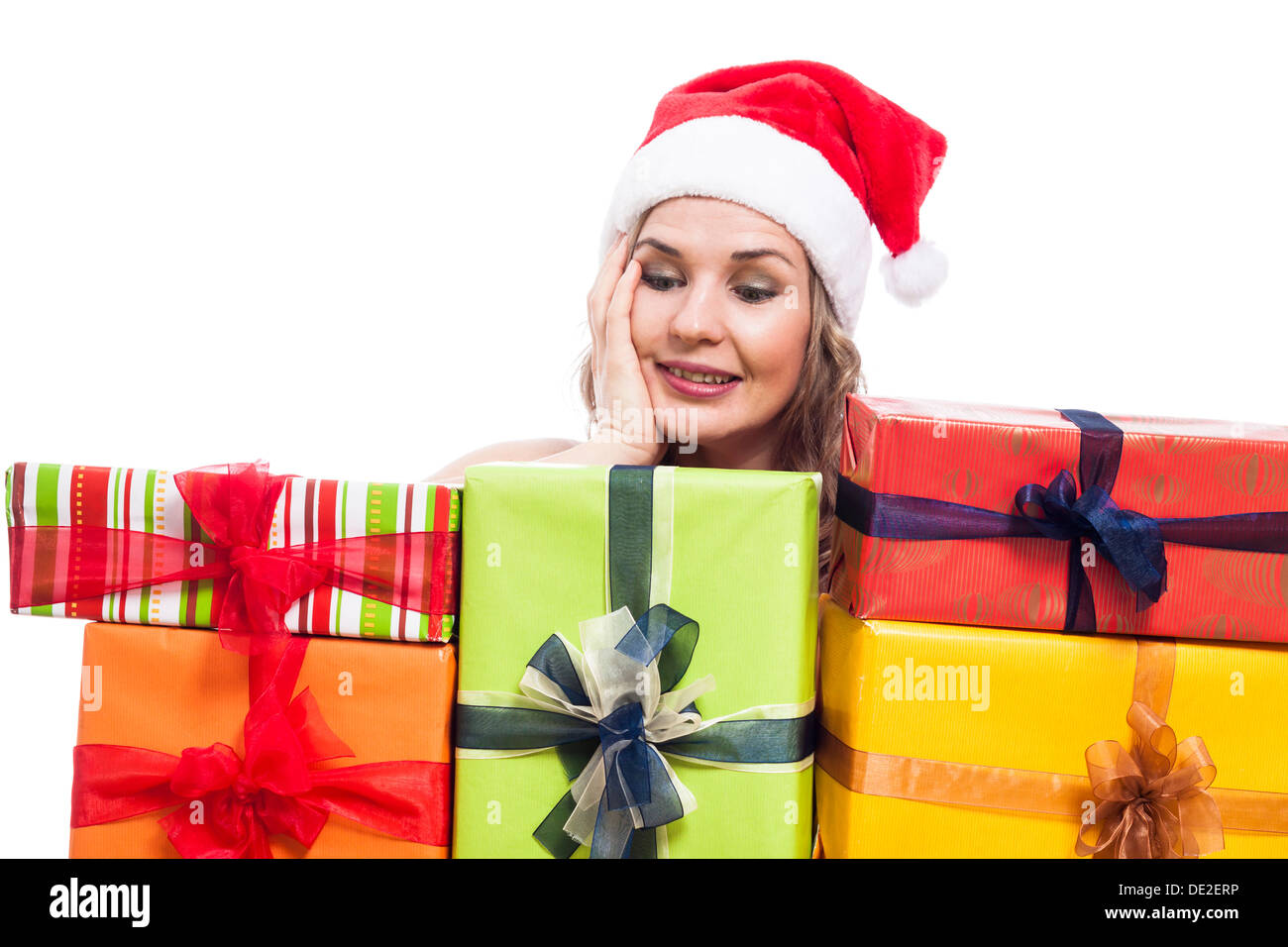 Pleased Christmas woman looking at many presents, isolated on white ...