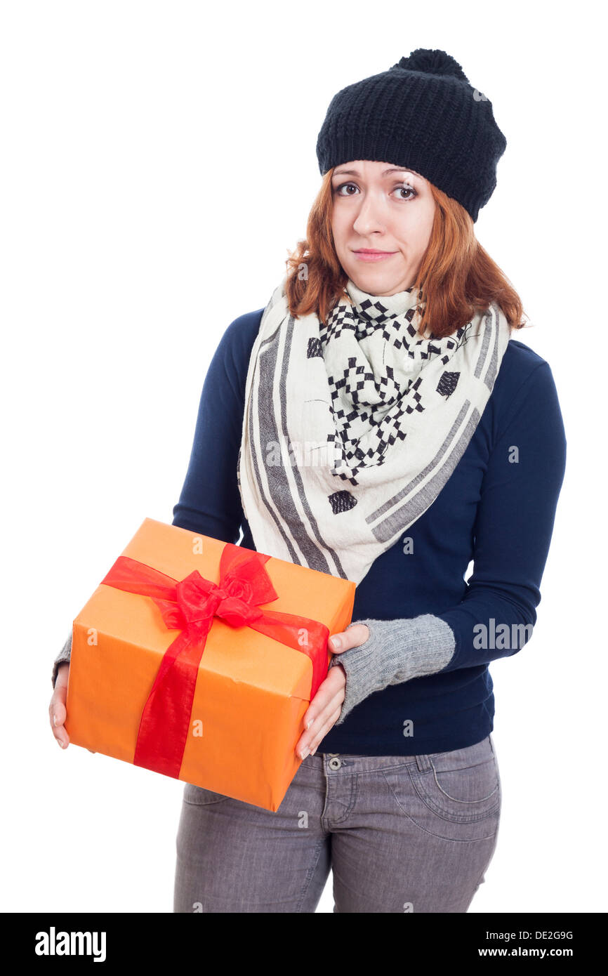 Disappointed winter woman holding present, isolated on white background ...