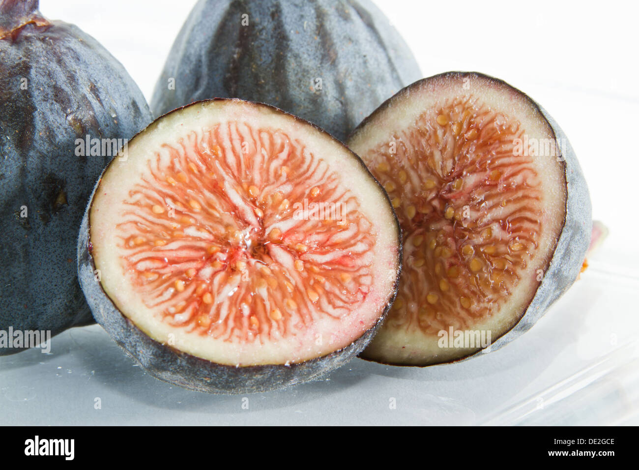 mission figs served on a glass plate isolate don a white background ...