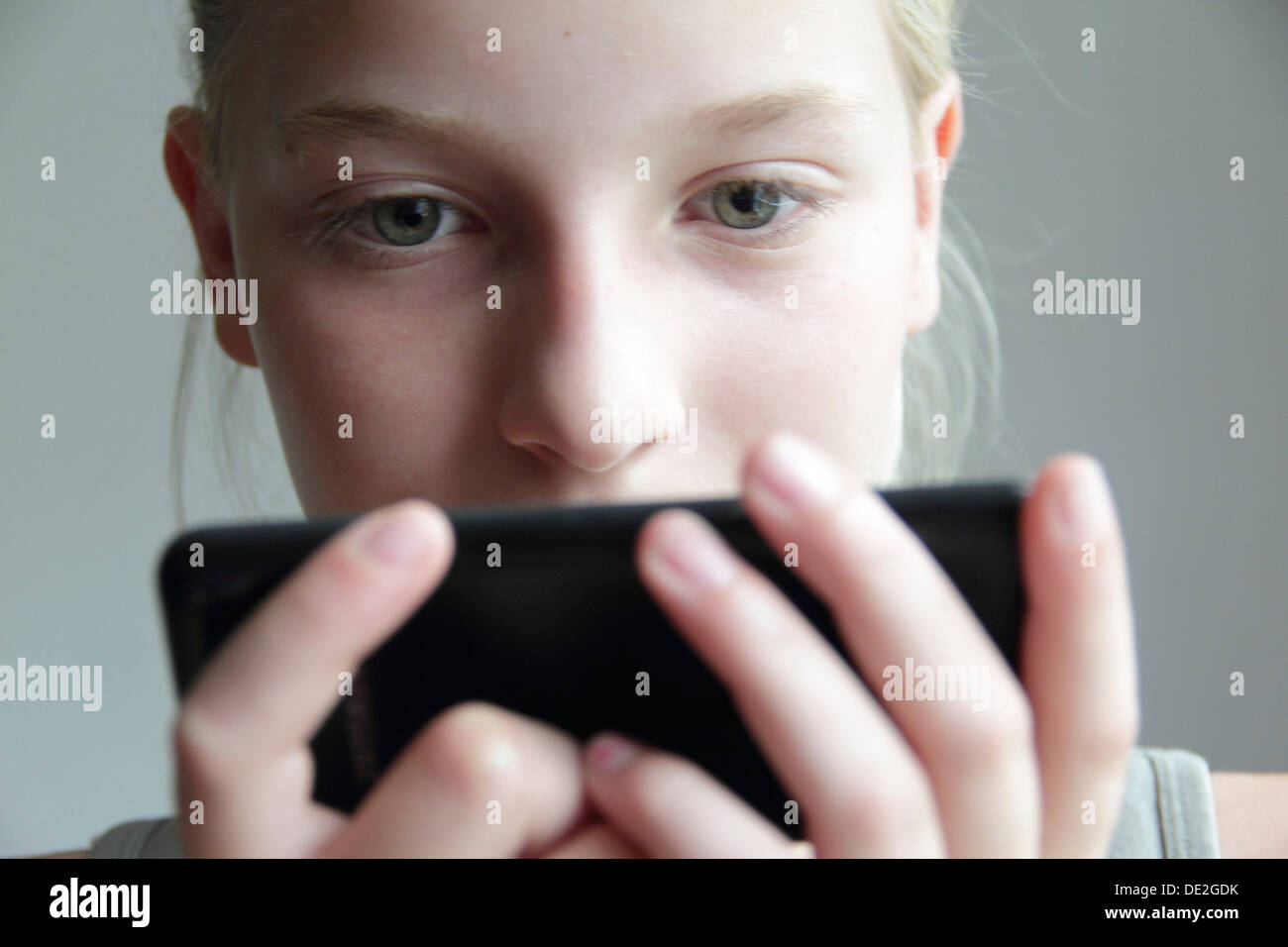 Girl looking at a smartphone Stock Photo - Alamy