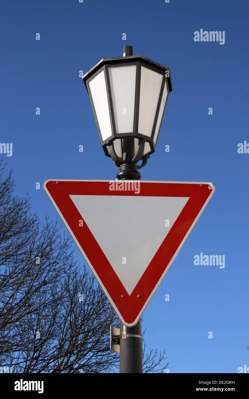 Traffic sign, give way, with street light Stock Photo - Alamy