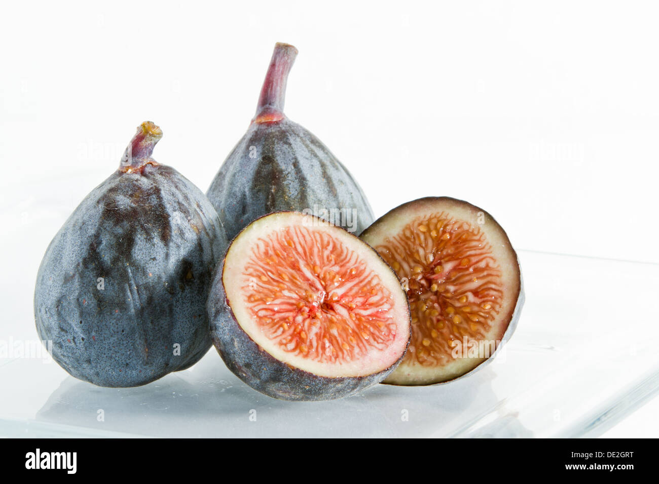 mission figs served on a glass plate isolate don a white background ...