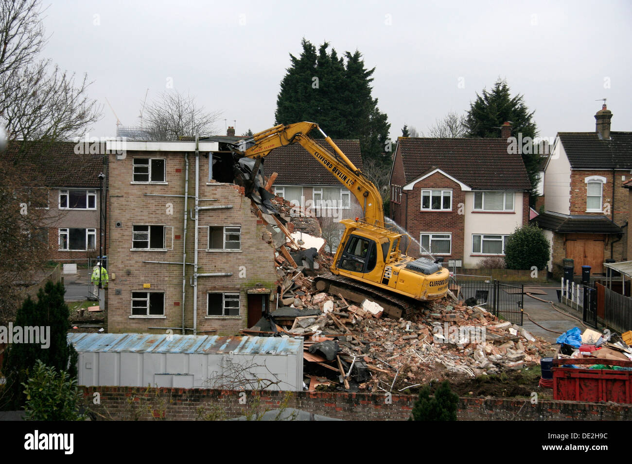 The Demolition of a Small block of Flats using an excavator. Water ...