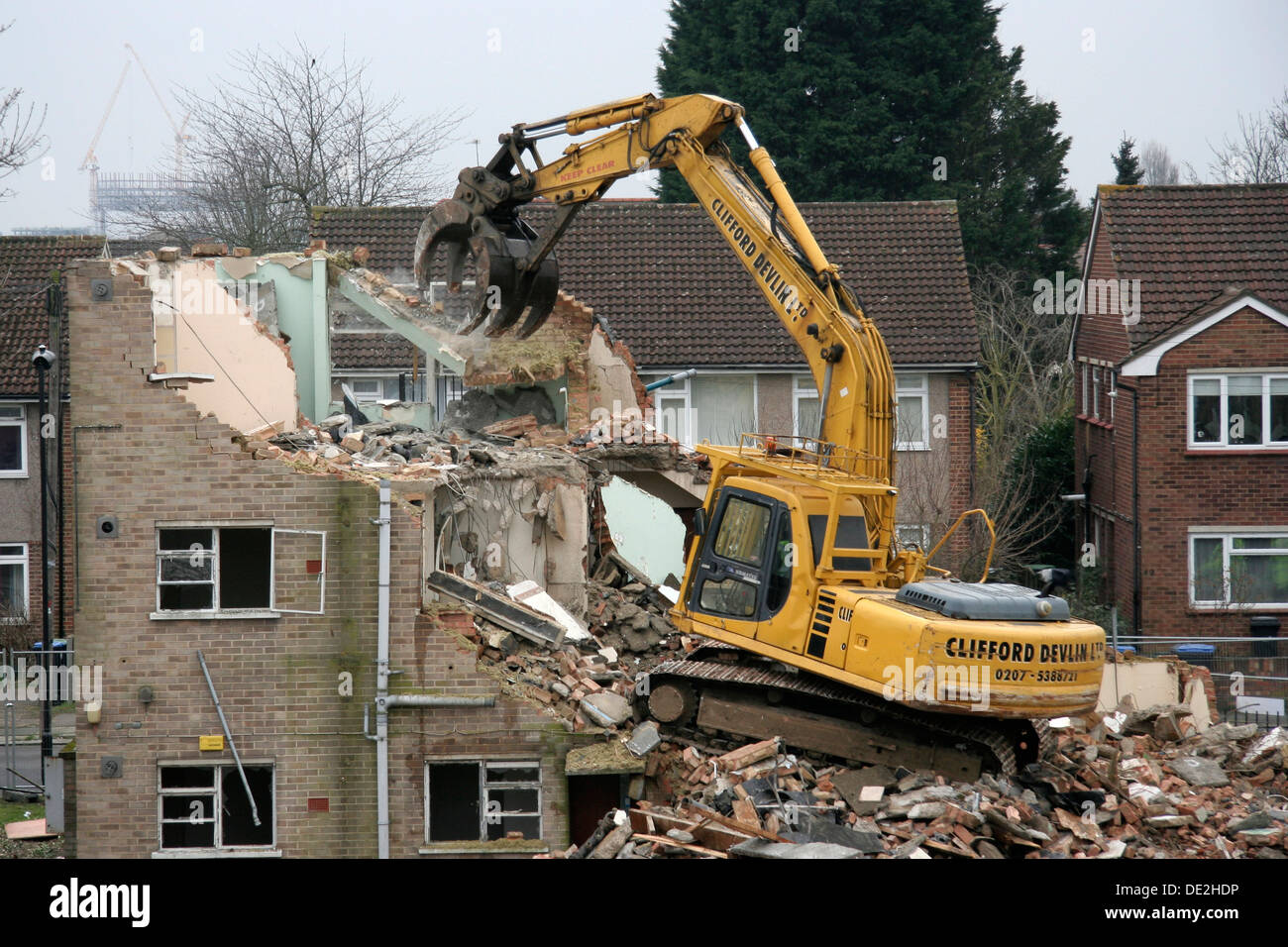 The Demolition of a Small block of Flats using an excavator Stock Photo ...