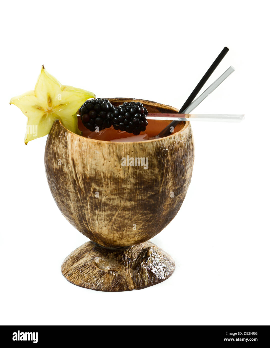 cocktail served in a coconut shell glass garnished with a carambola ...