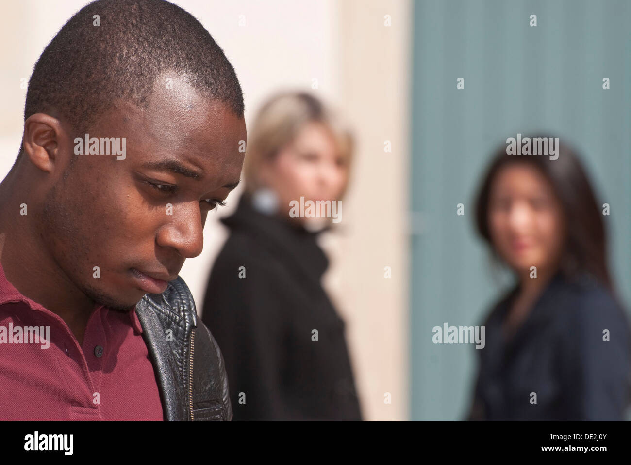 Coloured young man and two girls who are having a conversation Stock ...