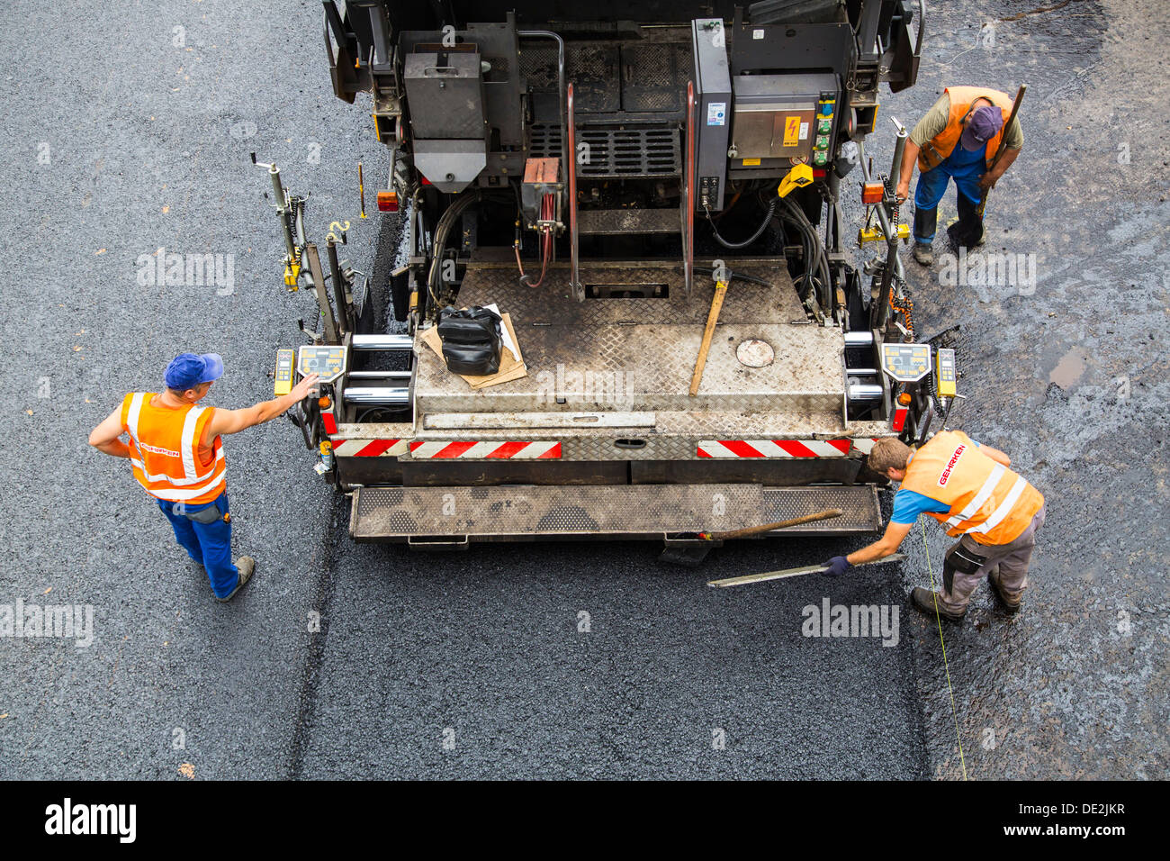 Inner-city road construction site. Asphalted work on a major road ...