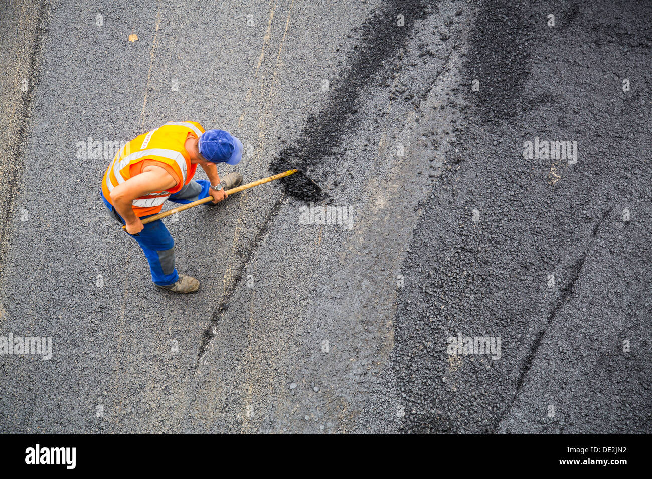 Inner-city road construction site. Asphalted work on a major road ...