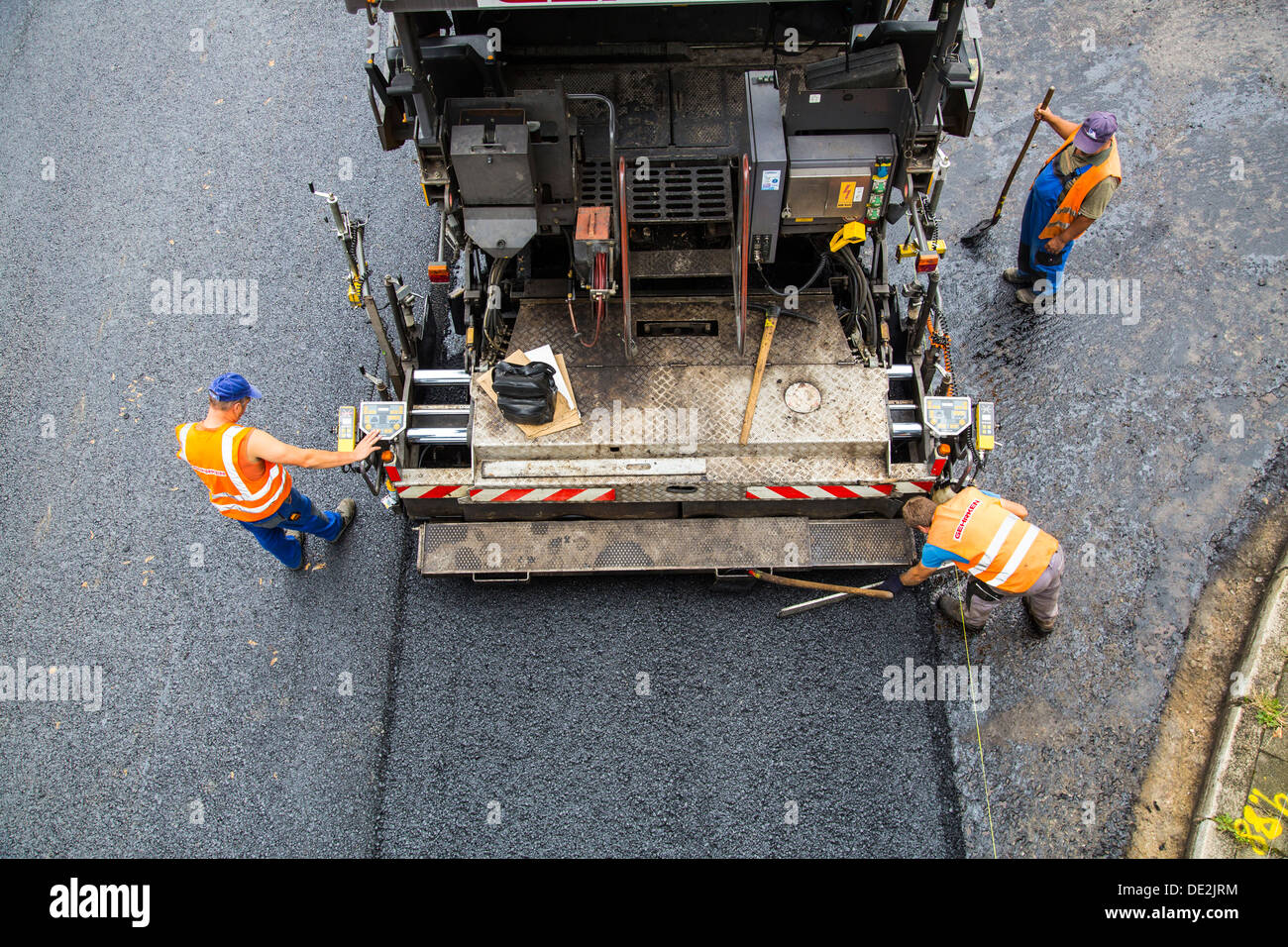 Inner-city road construction site. Asphalted work on a major road ...