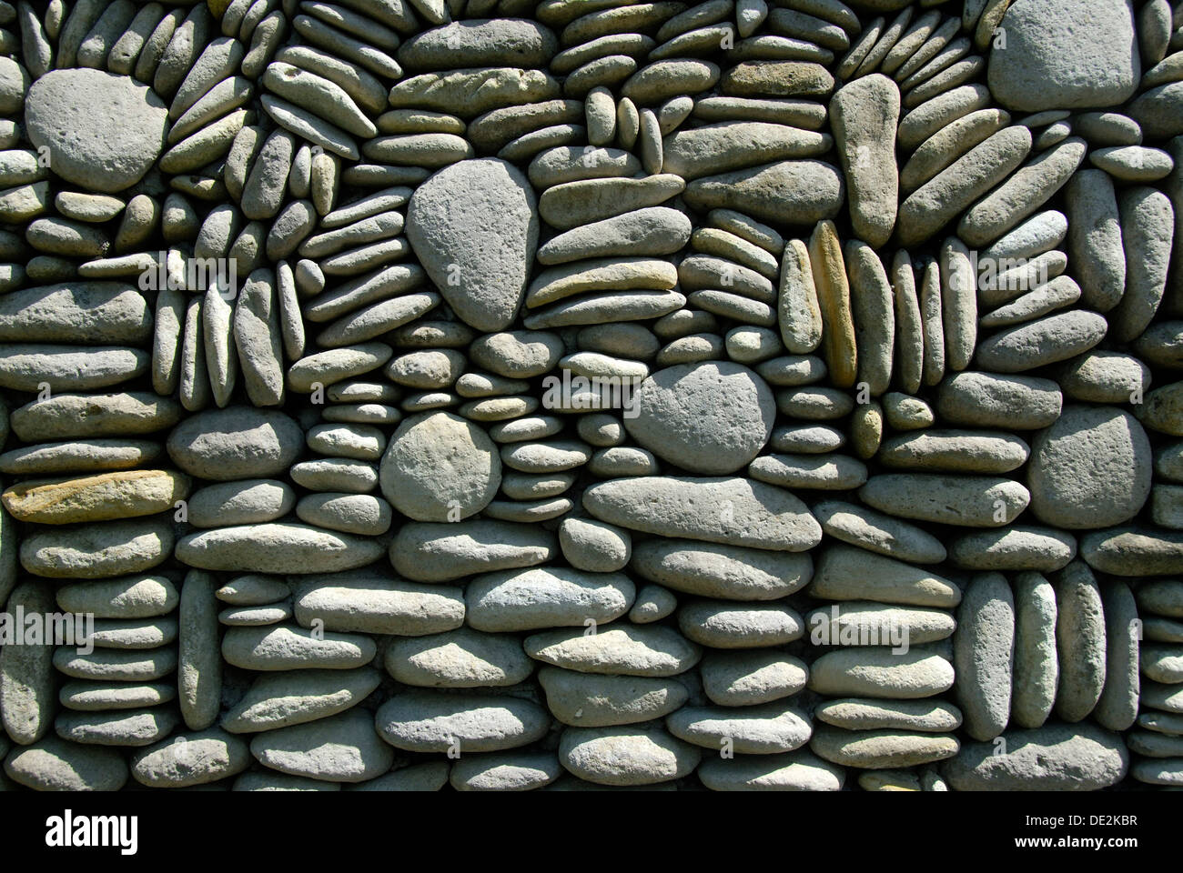 Pebbles artfully piled on top of each other as a wall, near Ubud, Bali ...