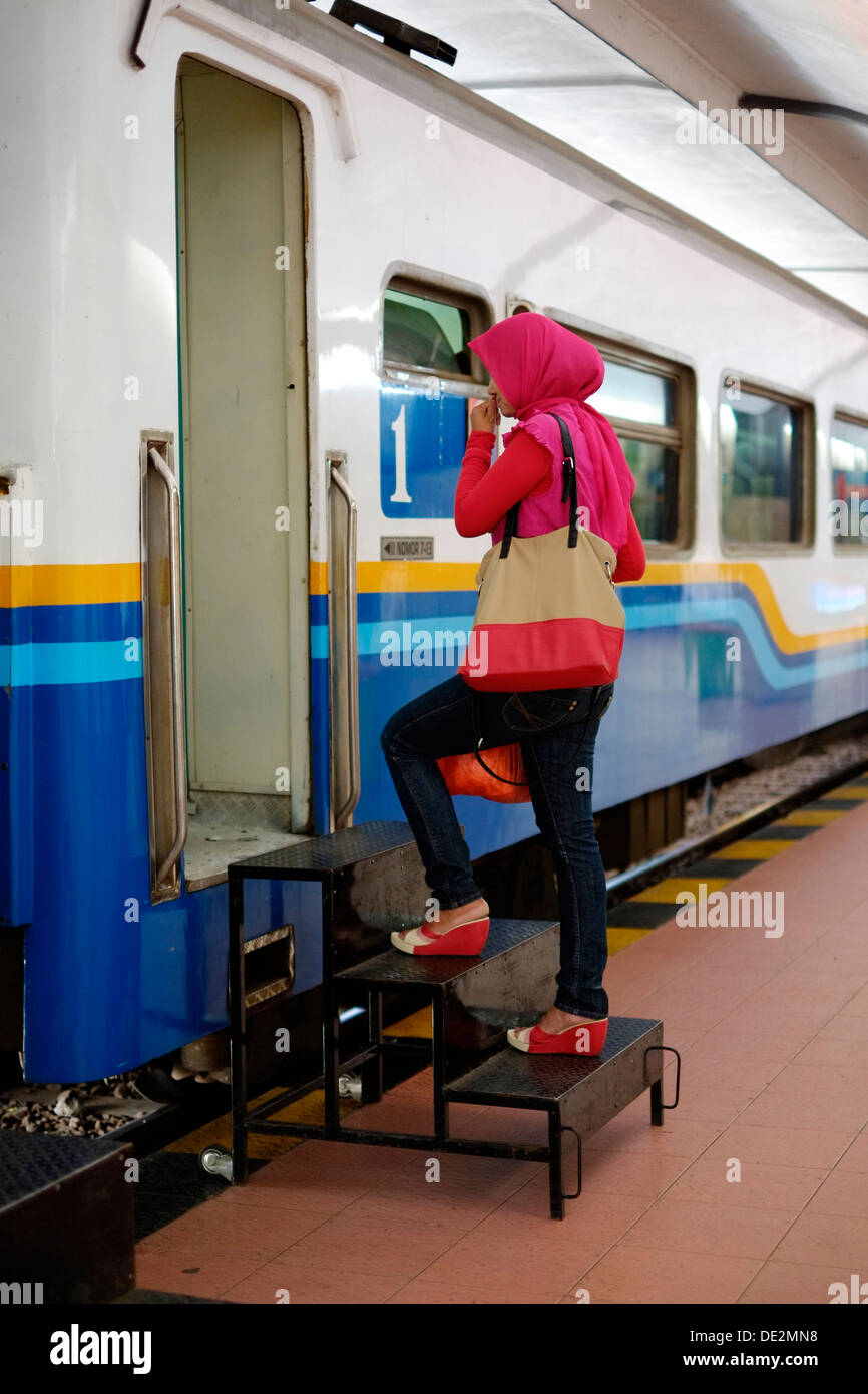 Woman boarding train hi-res stock photography and images - Alamy