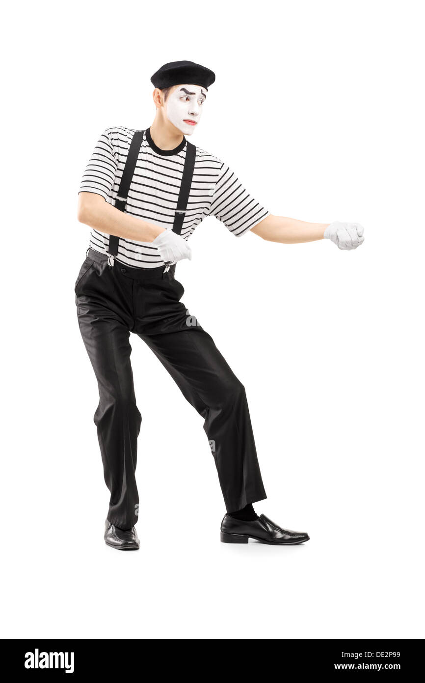 Full length portrait of a male mime artist performing pulling virtual ...