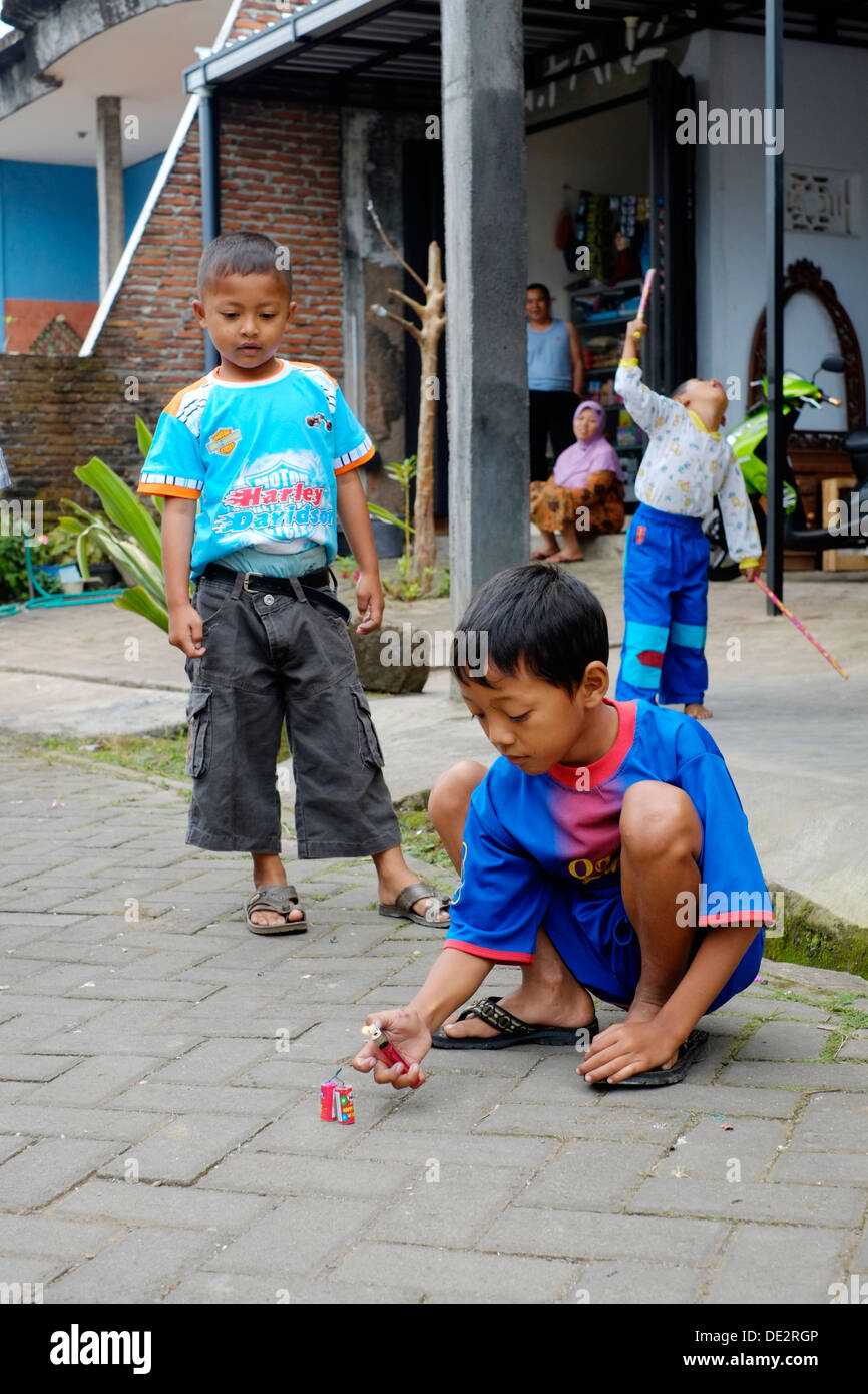 very young children playing with fireworks unsupervised in a village ...