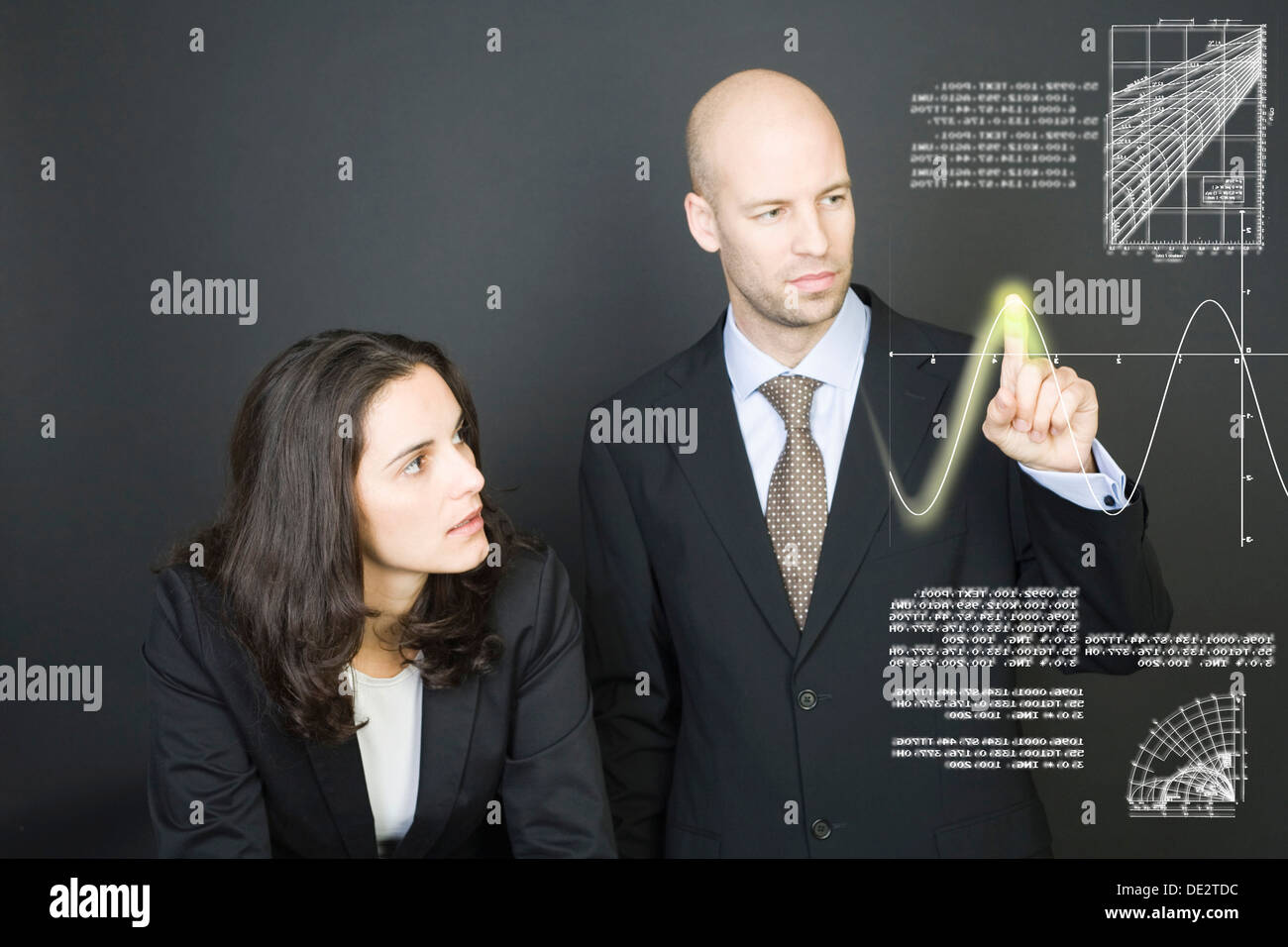 Virtual screen, young business man pressing his finger on a graph on a ...