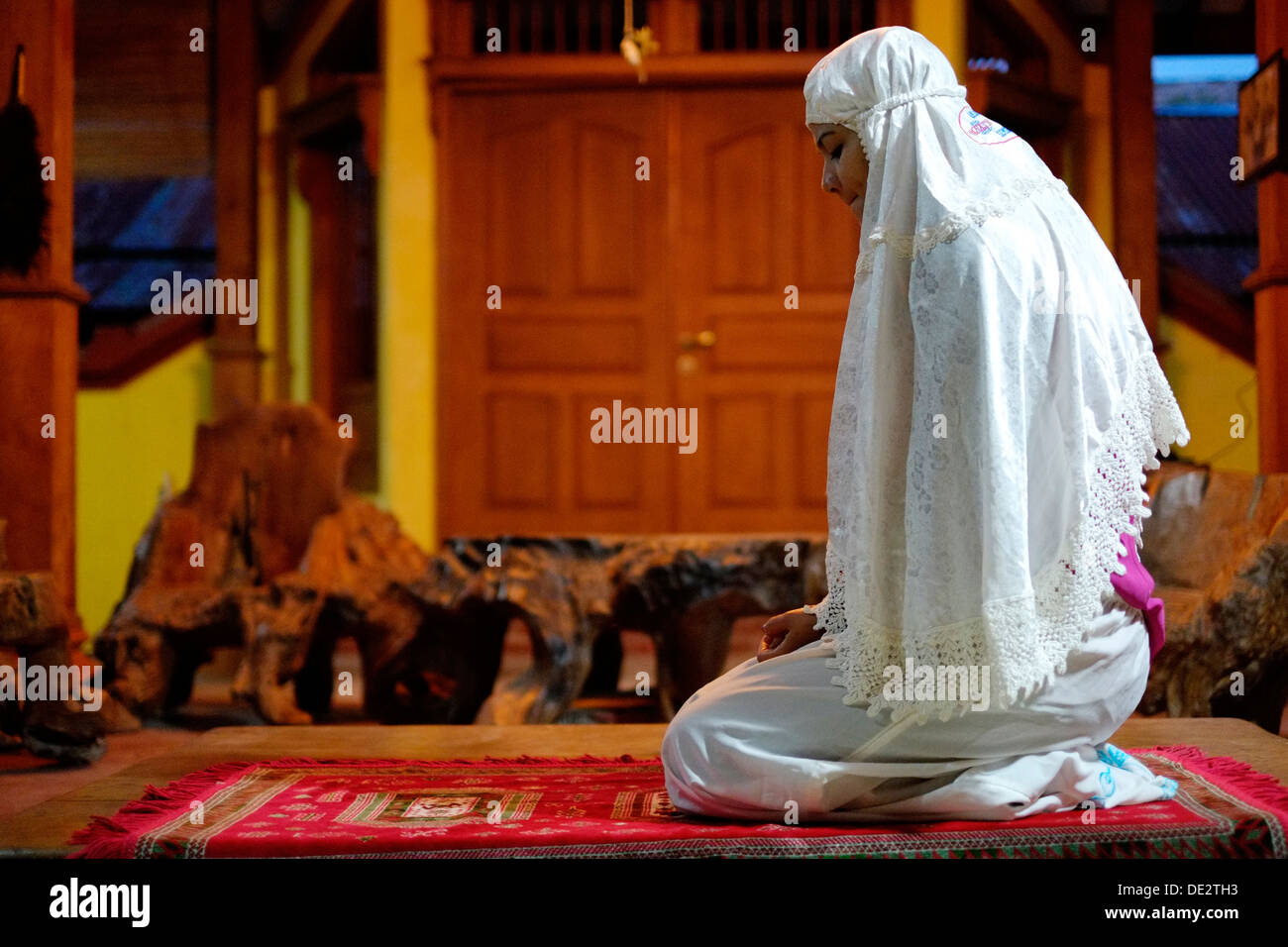 indonesian muslim woman praying in the early hours of the morning at ...