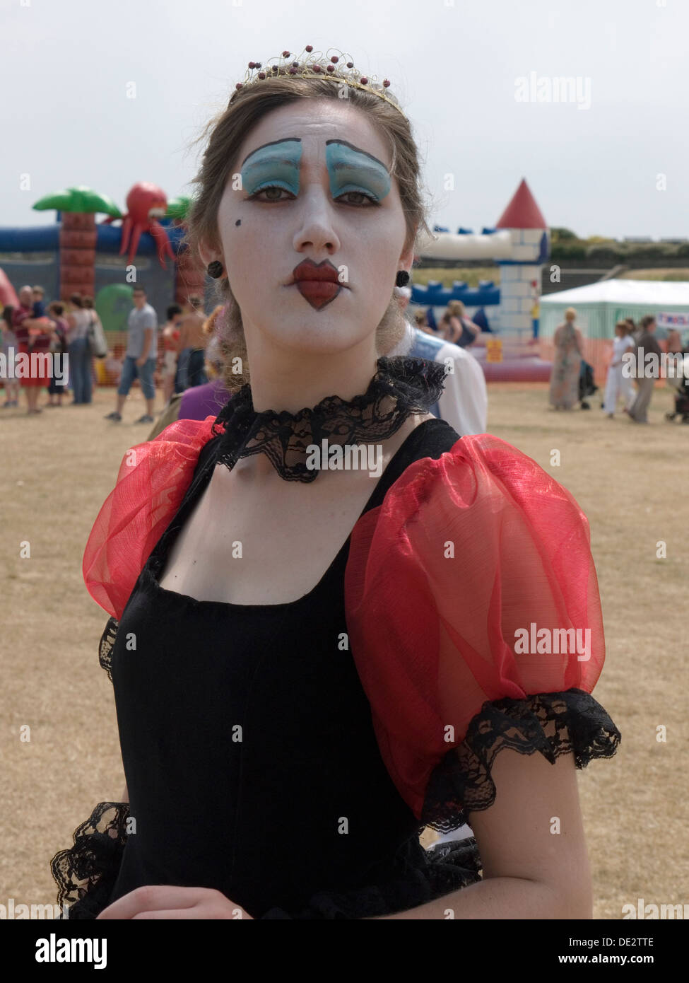 character from alice in wonderland act out scenes during a public ...