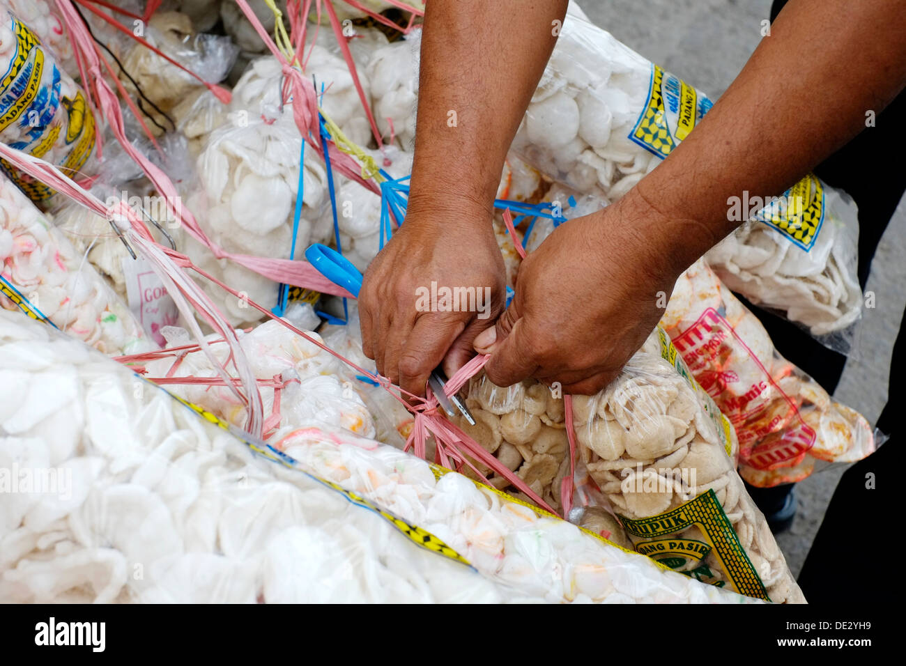 vendor cutting bag free for customer at a store specialising in locally ...