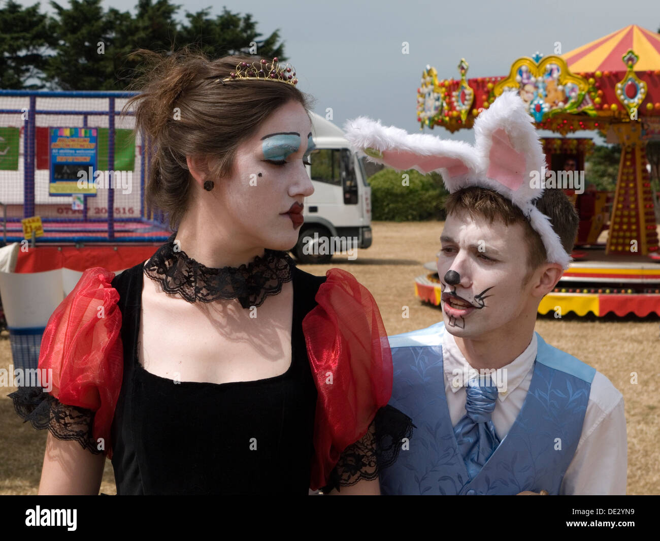 character from alice in wonderland act out scenes during a public ...
