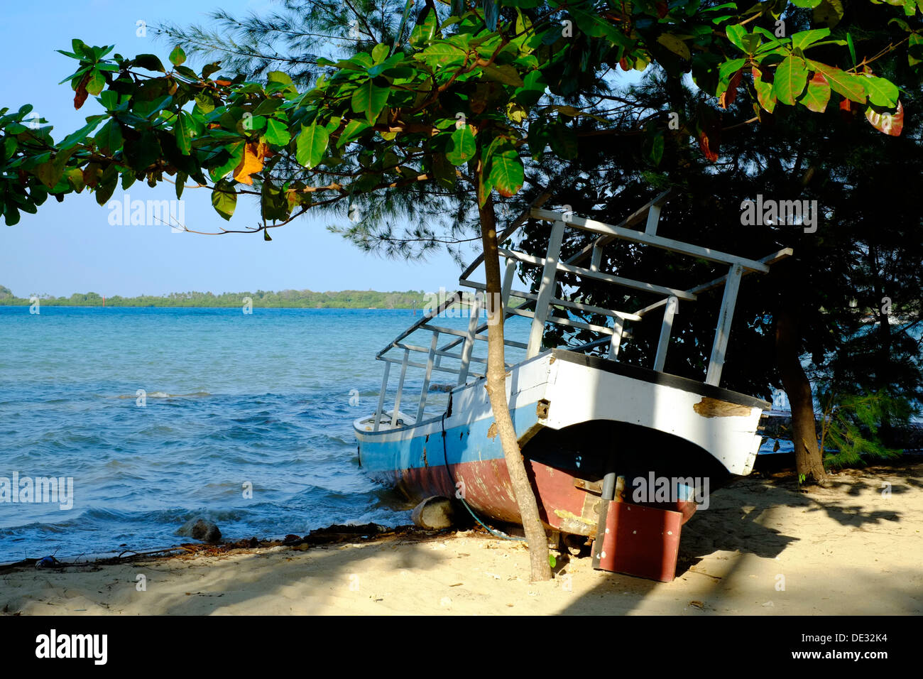 abandoned and derelict traditional fishing boat on a beach karimunjawa ...