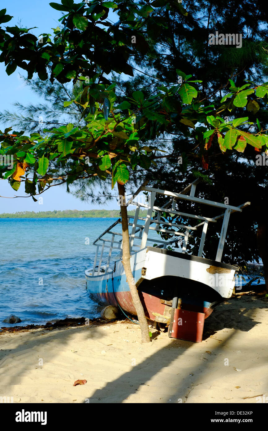 abandoned and derelict traditional fishing boat on a beach karimunjawa ...