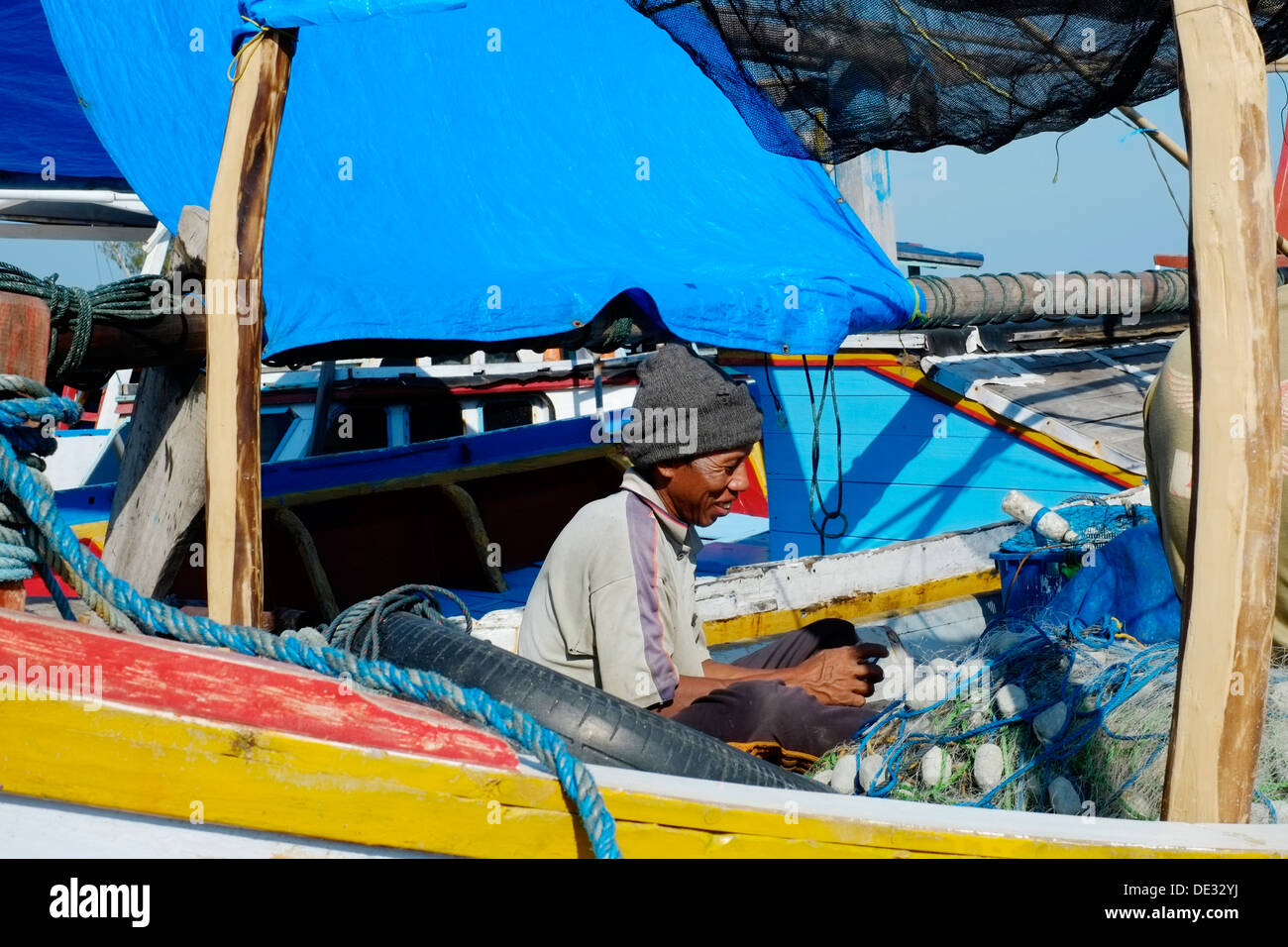 local fisherman aboard his boat working on his nets karimunjawa island ...
