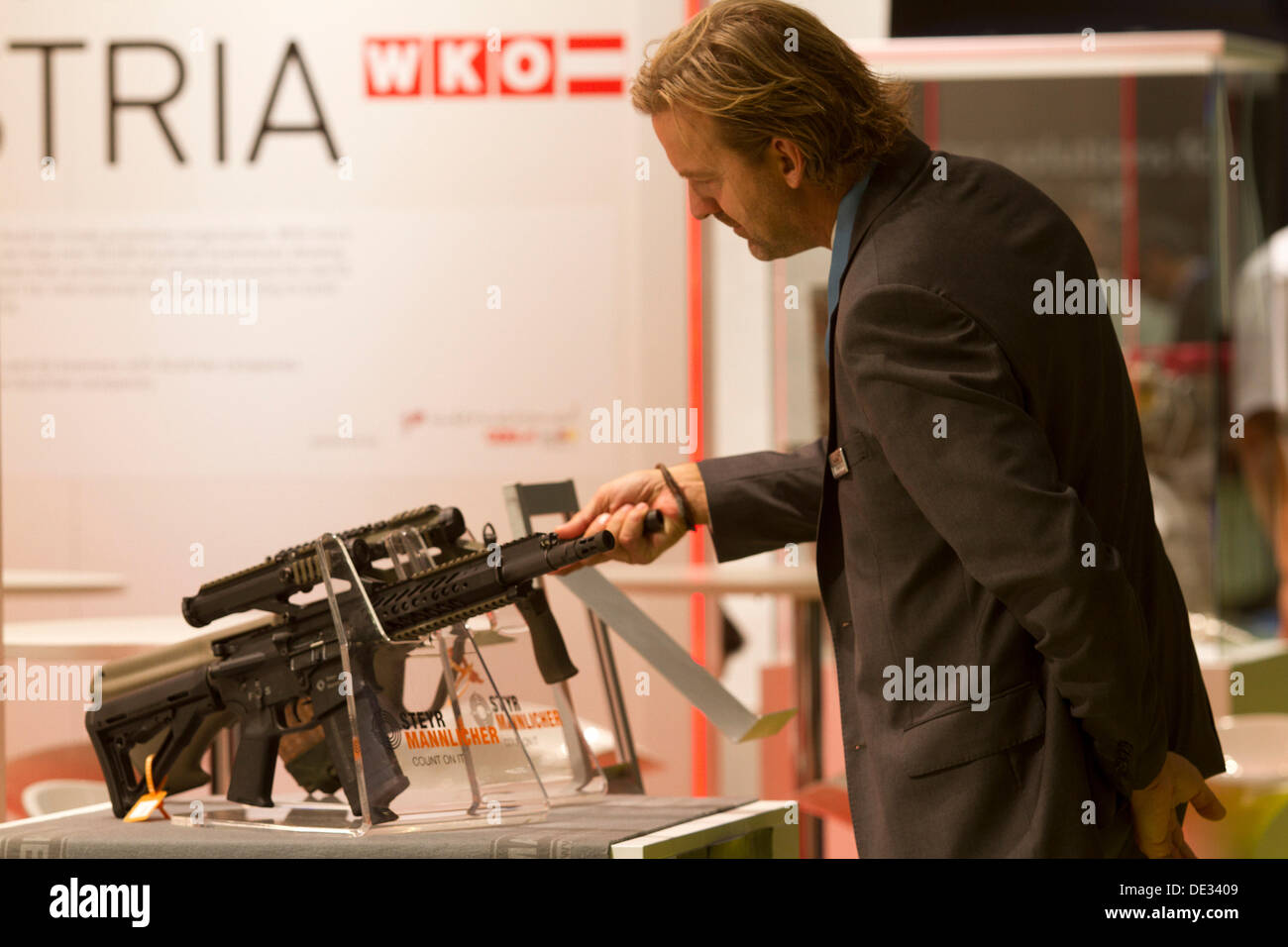 London, UK. 10th Sep, 2013. A man looks at an assault rifle at the ...