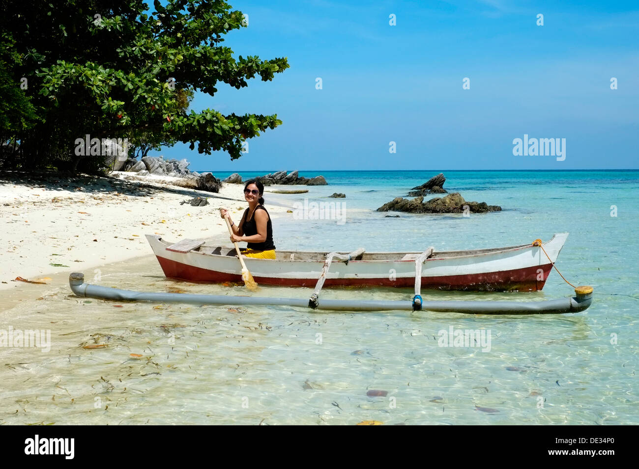 young local indonesian woman enjoying the pristine seas and beaches of ...