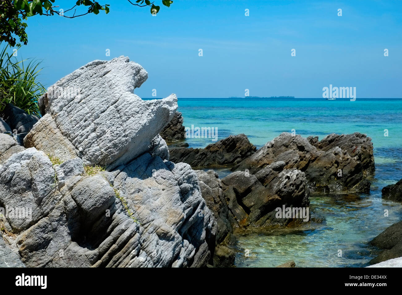 rocks and rock pool on deserted beach on paradise island of karimunjawa ...