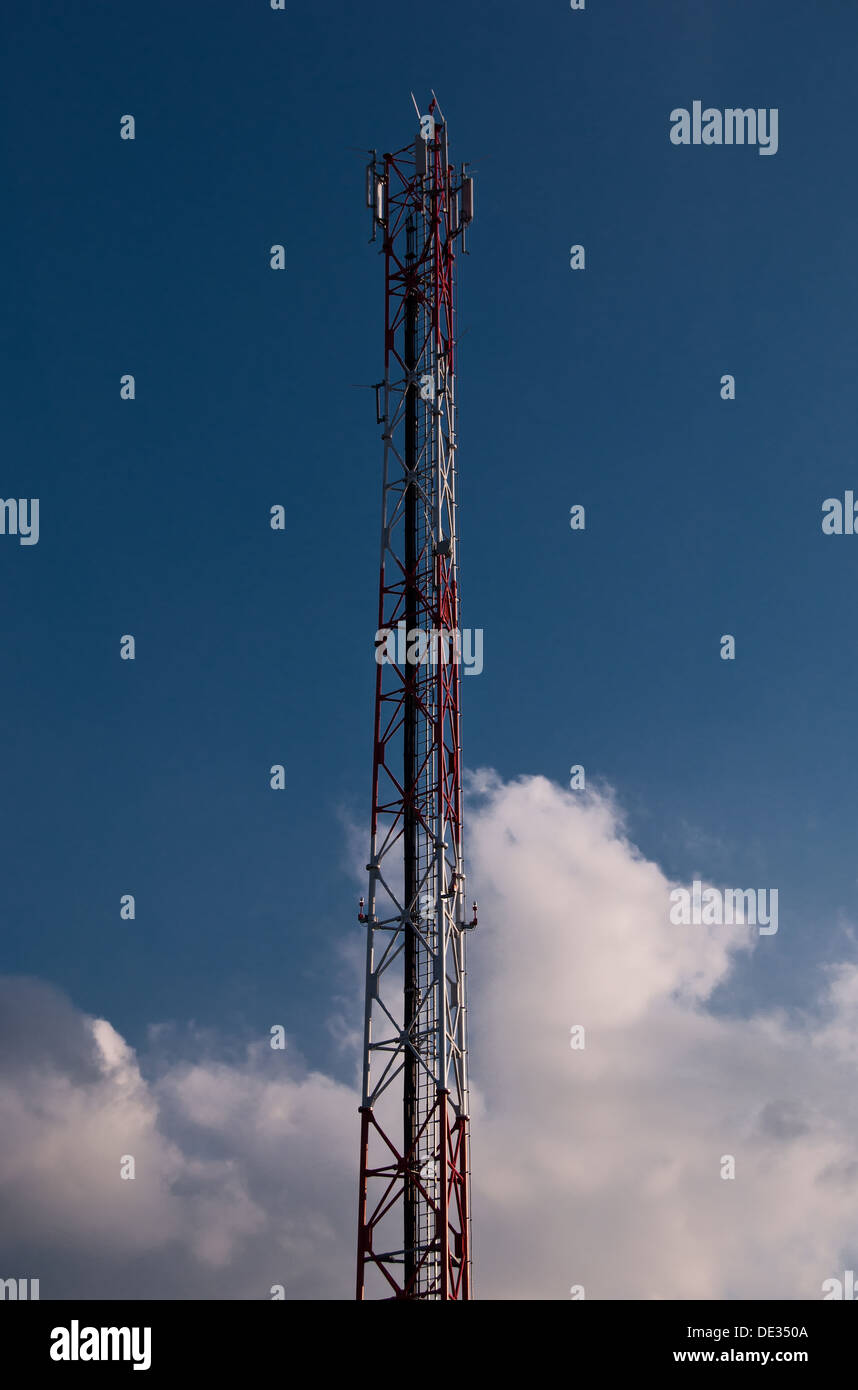GSM antennas tower on a blue sky background Stock Photo - Alamy