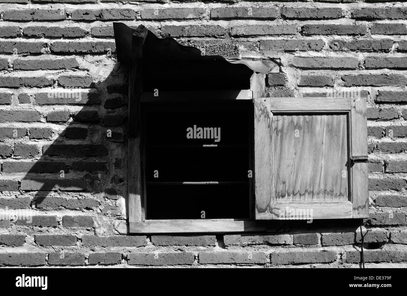 simple basic open wooden window in the wall of a rural village house ...