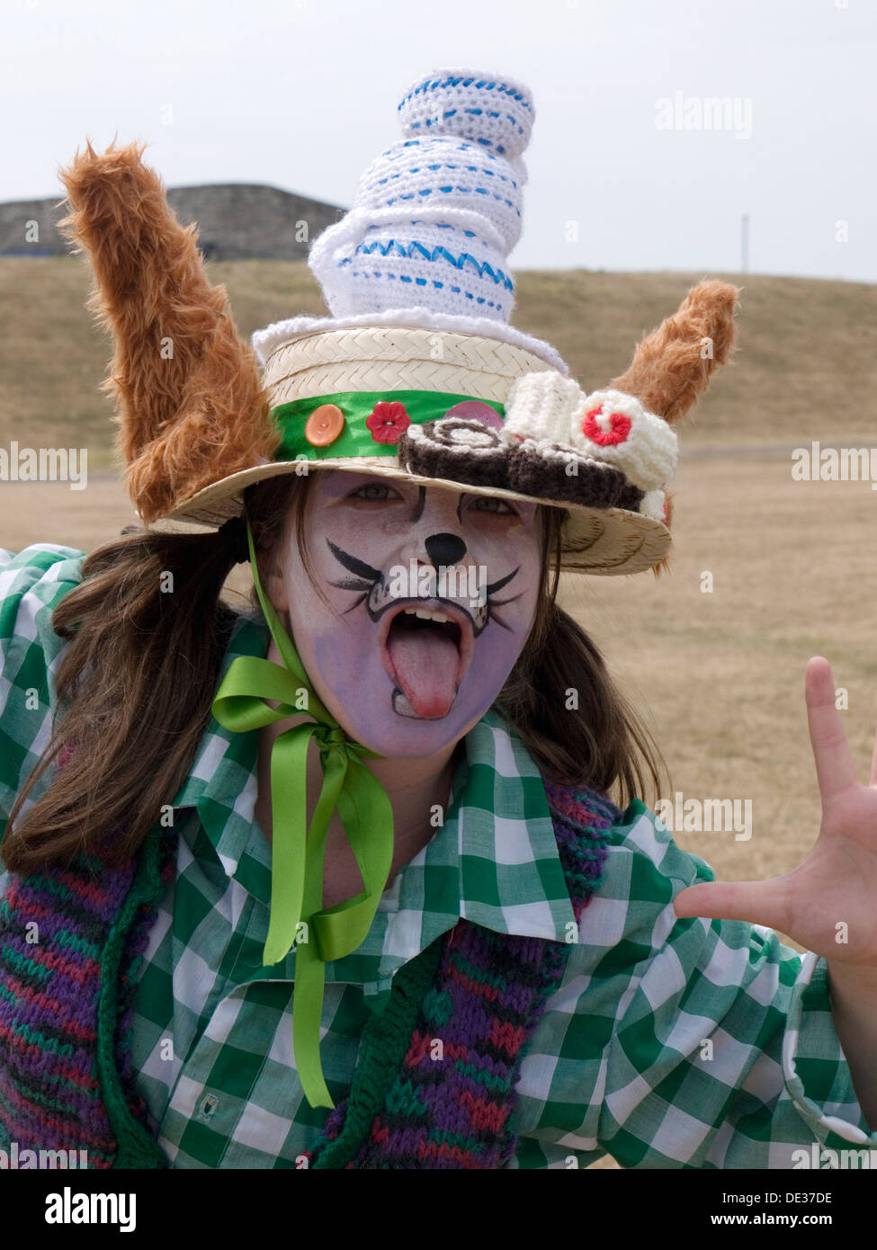 character from alice in wonderland act out scenes during a public ...