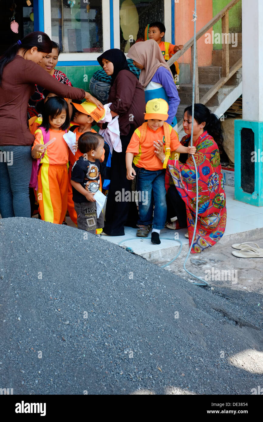 children play outside of their classroom as school building work ...