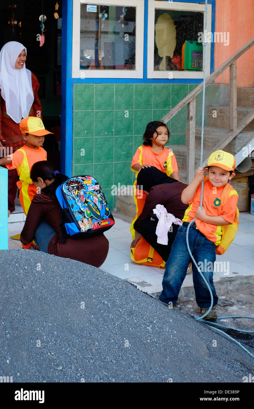 children play outside of their classroom as school building work ...