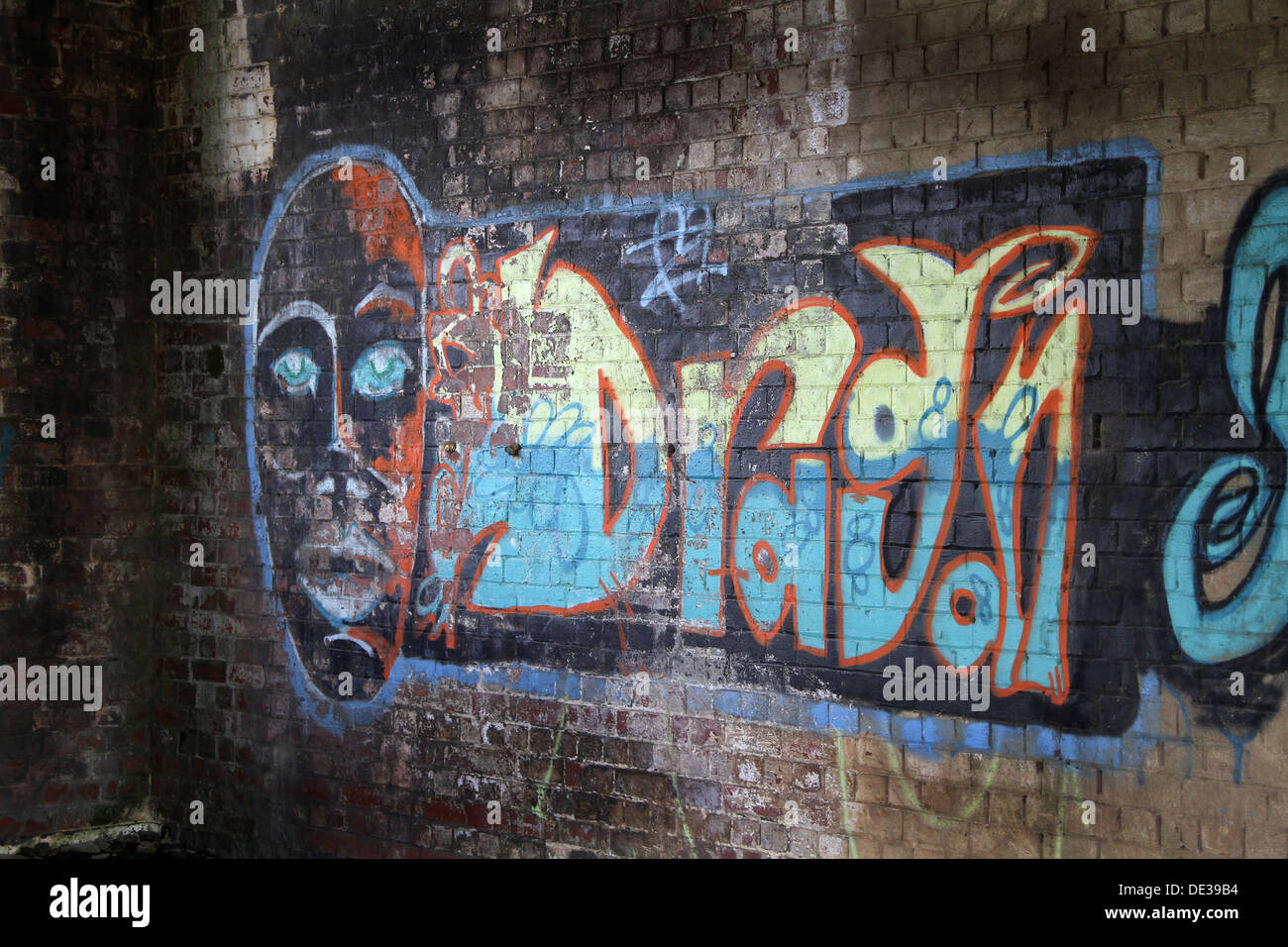 Graffiti on inside walls of old derelict engineering building Stock ...