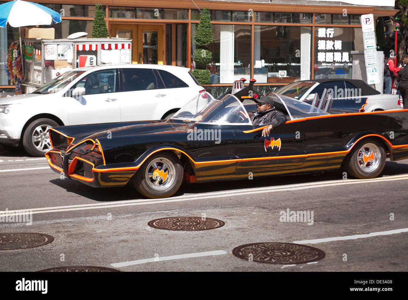 Man driving batmobile Stock Photo - Alamy