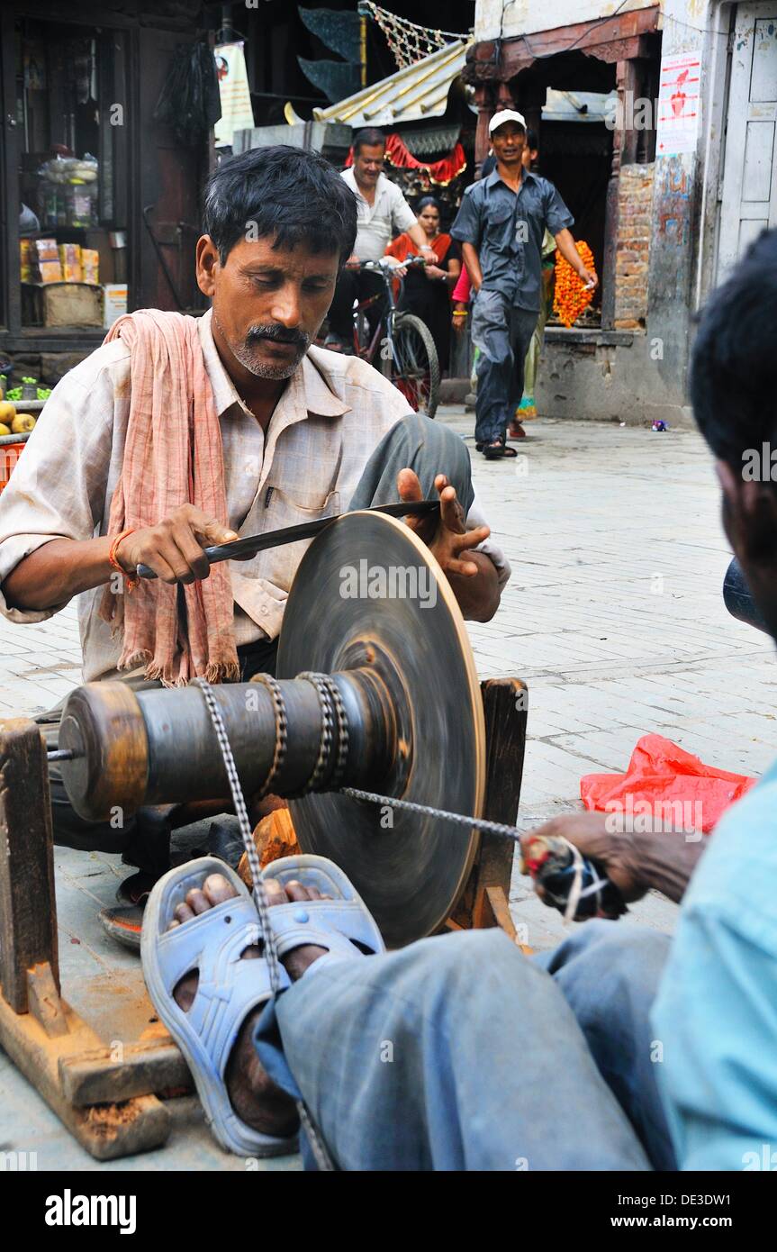 The man sharpening knife without mortar Stock Photo - Alamy