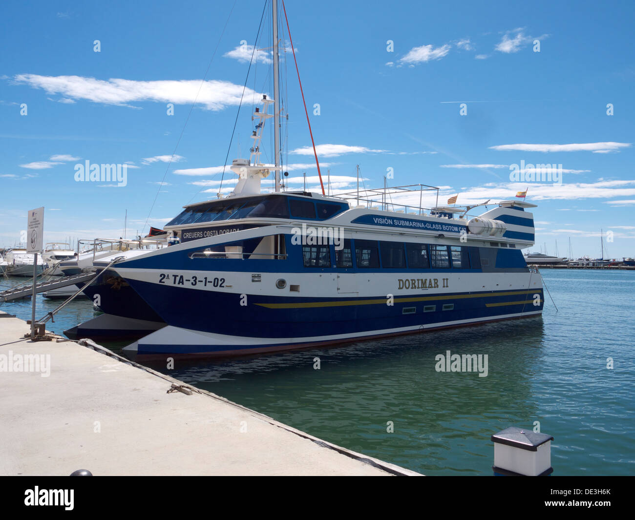Tourist boat in a fishing harbor Stock Photo - Alamy