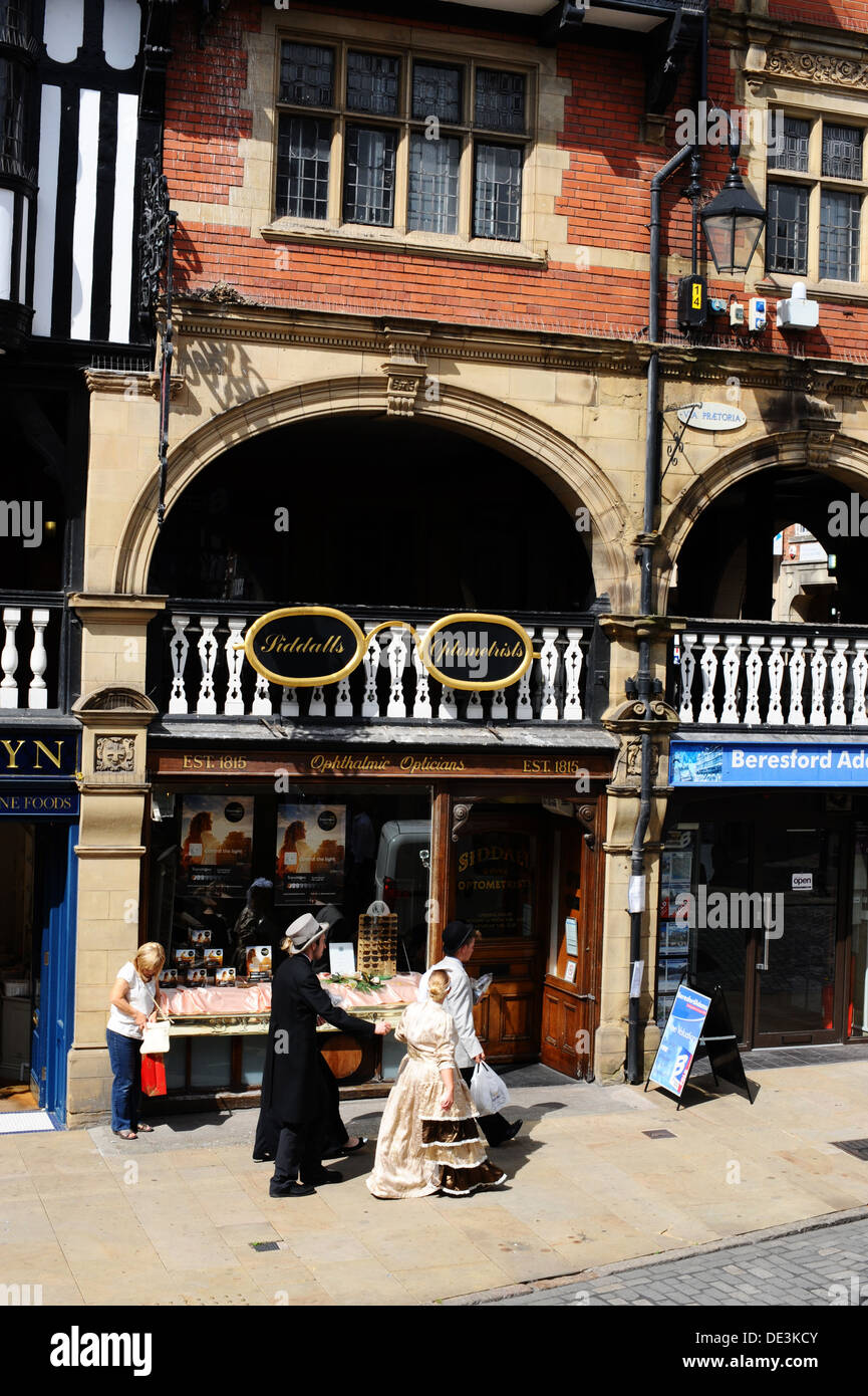 People in Victorian costume outside The Rows in Chester Stock Photo - Alamy