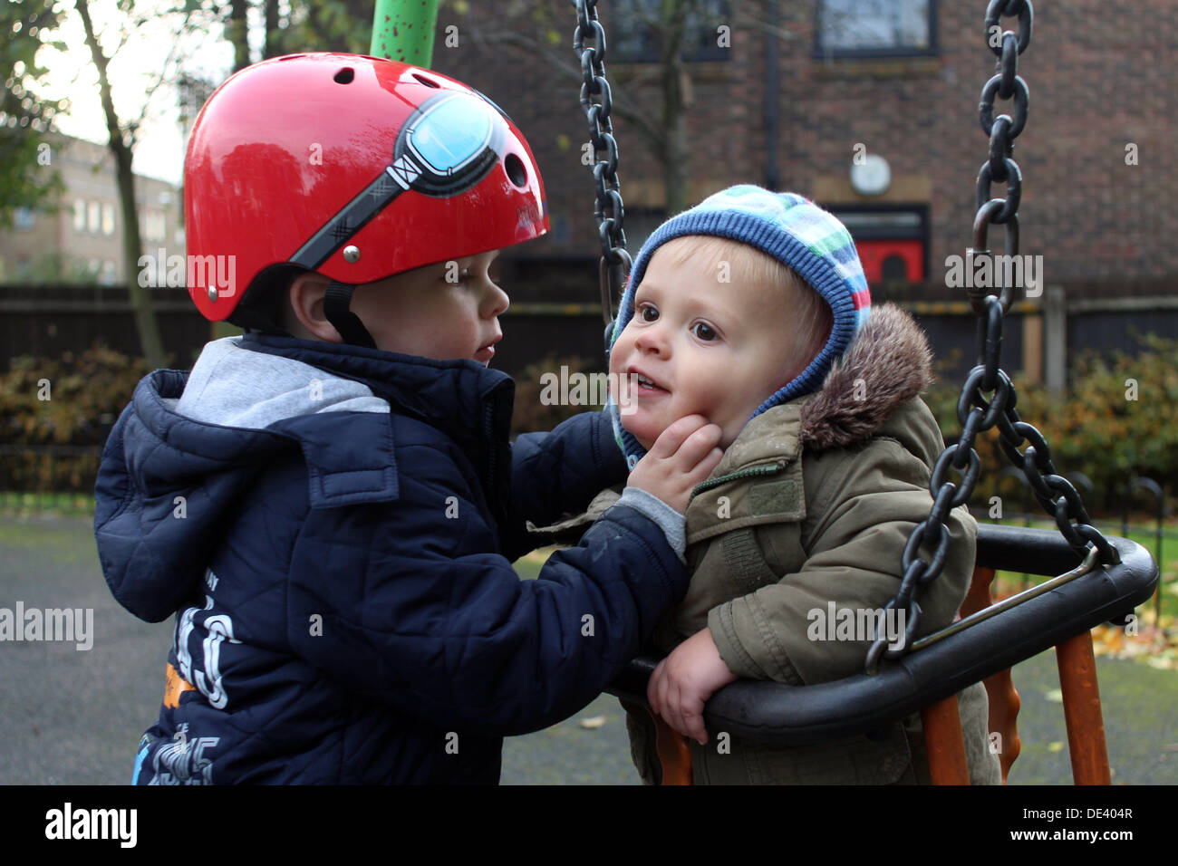 siblings playing together in the park Stock Photo - Alamy