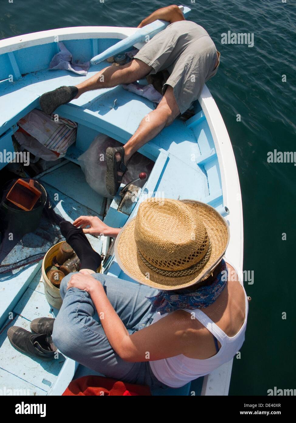 Aerial view of blue boat body of a man half sloping to the sea ...