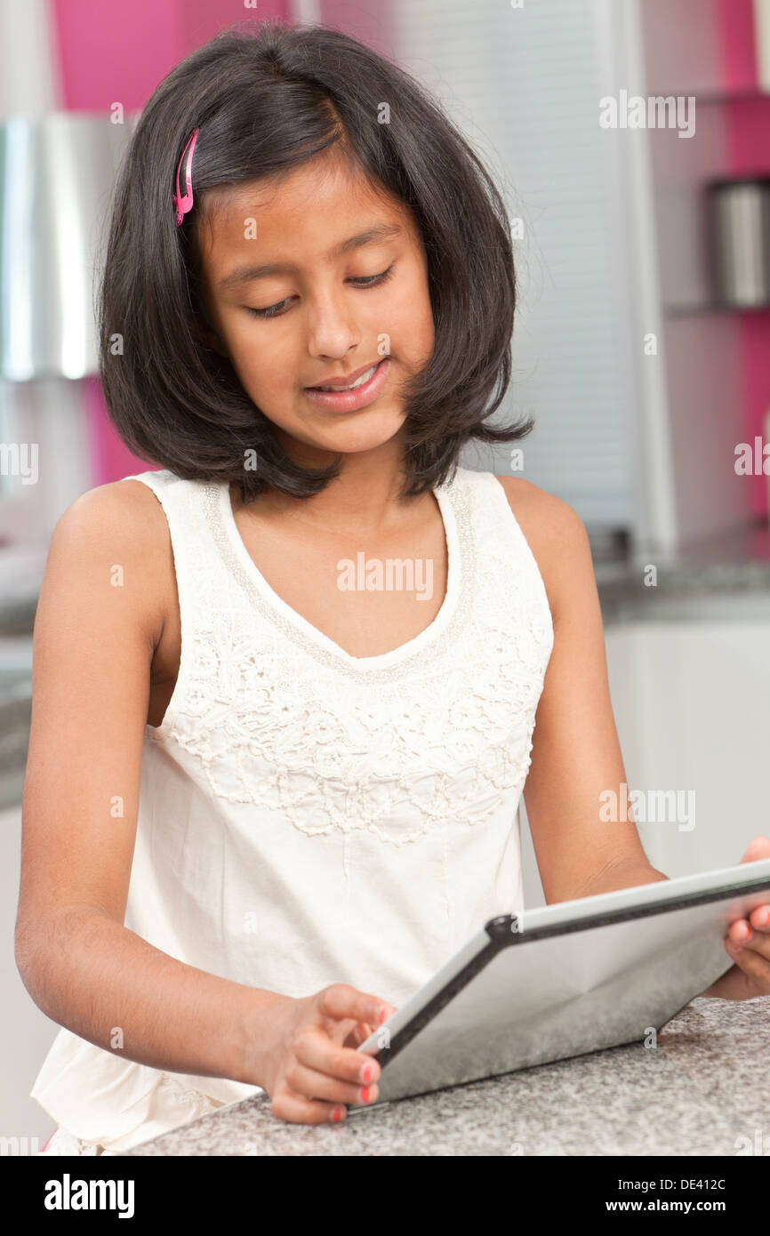 Asian Indian Girl Child Using Tablet Computer at Home Stock Photo - Alamy