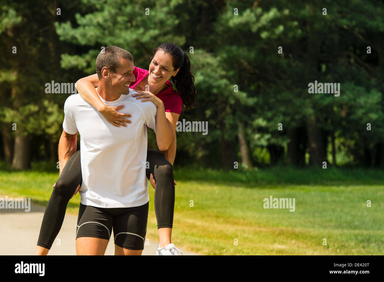 Sporty boyfriend giving piggyback ride to his girlfriend Stock Photo ...