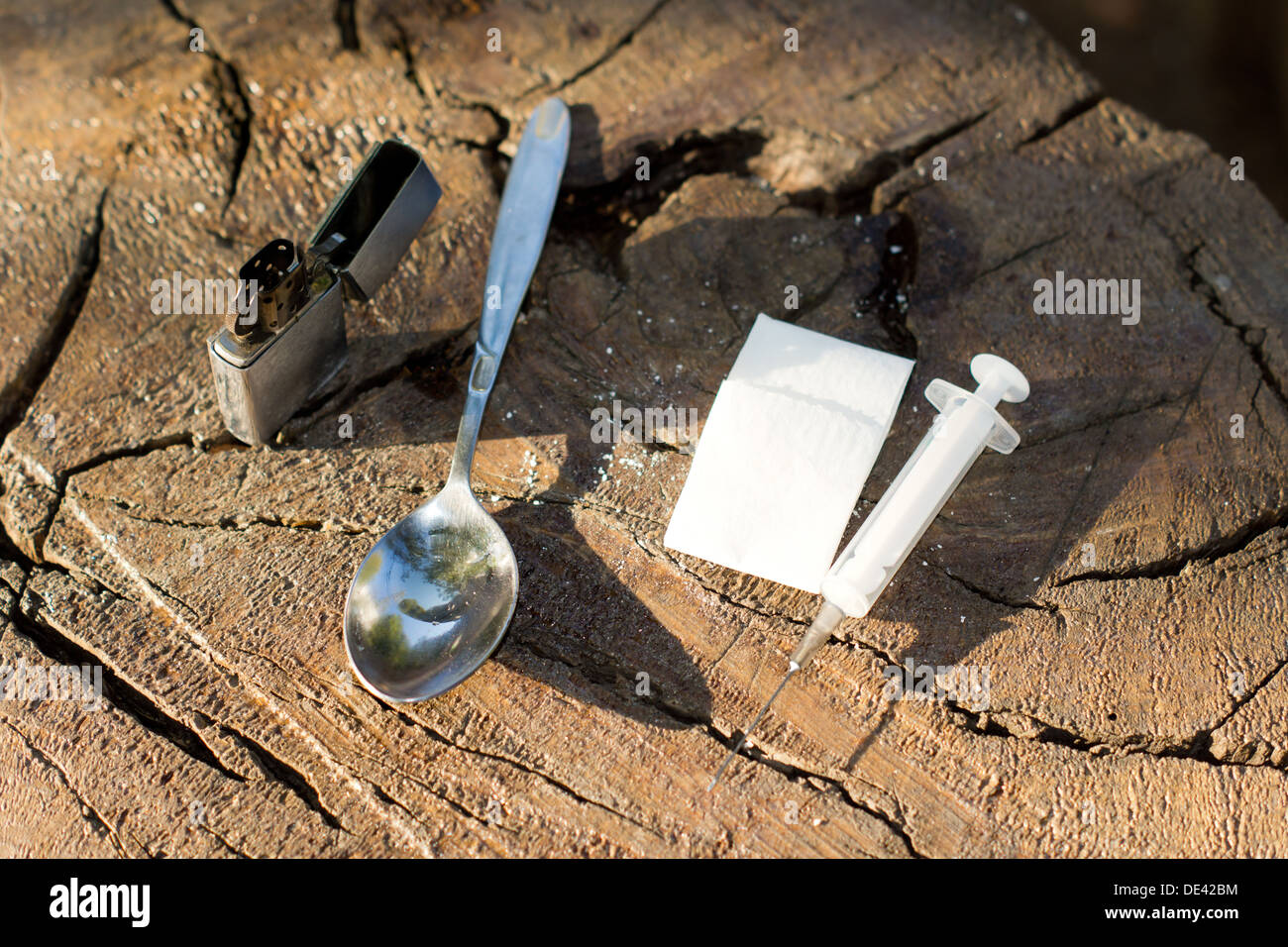 Close-up of objects, symbols of drug addiction: a spoon, a lighter and ...