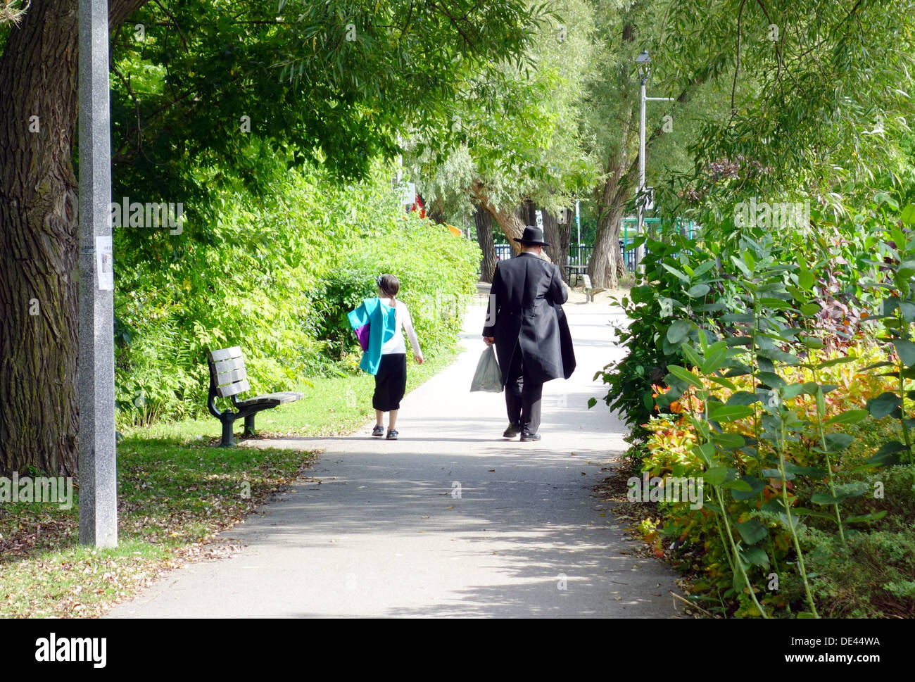 Jewish man and young kid walking in a park in Toronto, Canada Stock ...