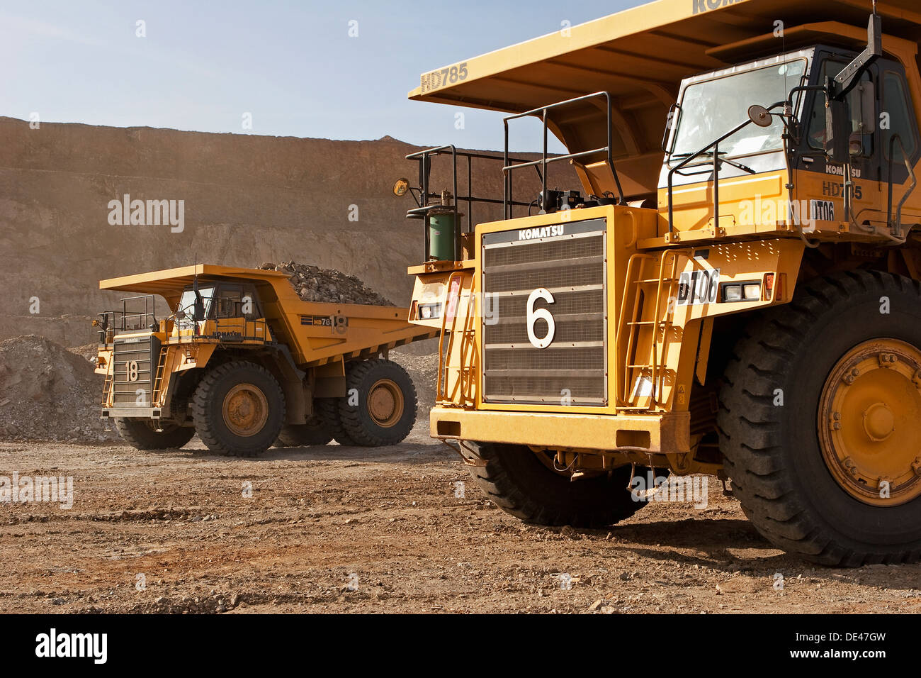 Close view of haul trucks in open cast surface gold mining pit ...