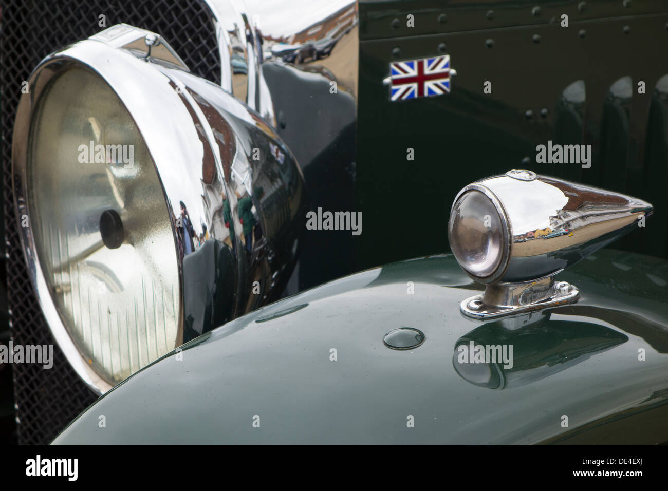 The chrome headlight (headlamps) on the front of a classic British ...