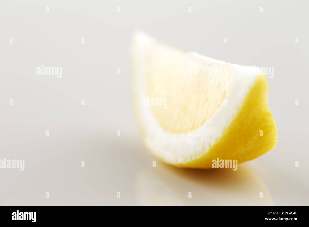 A fresh organic lemon photographed in an abstract manner on a white ...