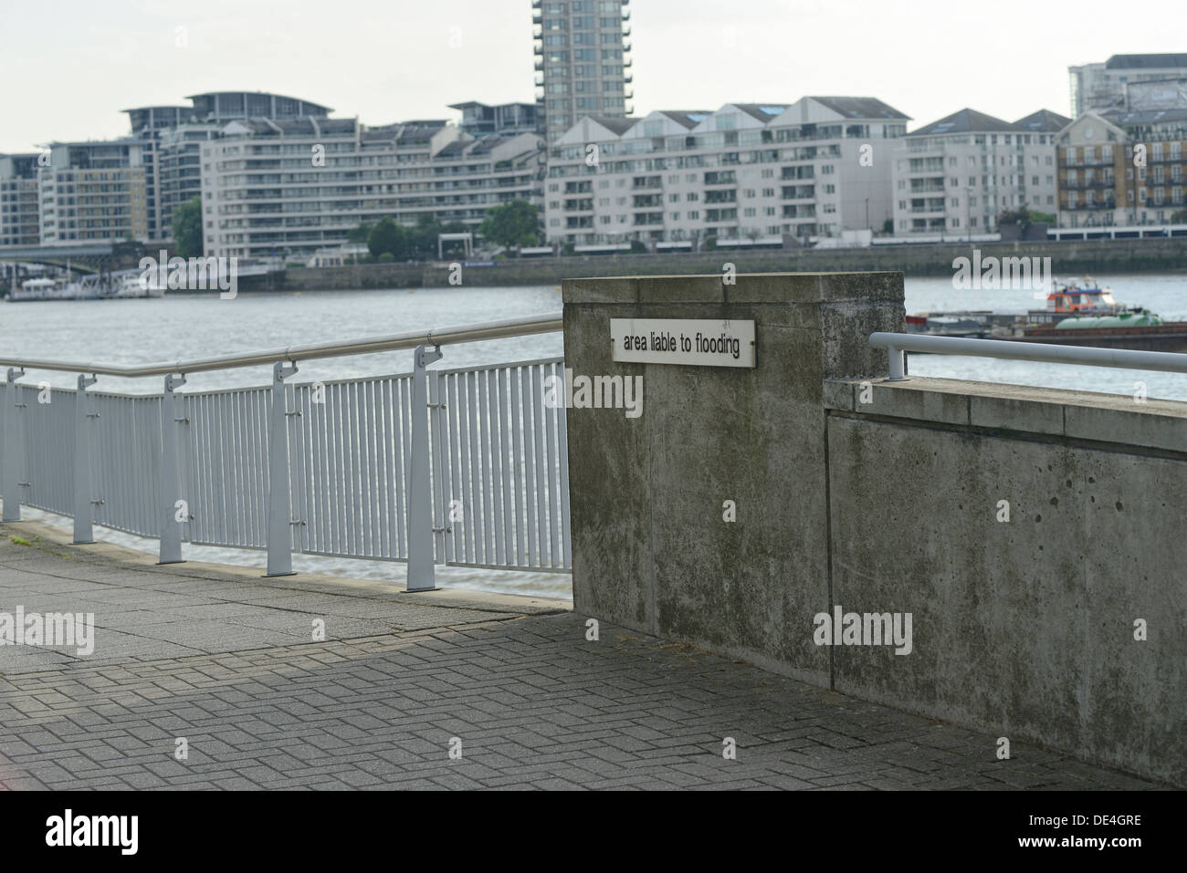 Flood warning at one of many railings along the river Thames in London ...
