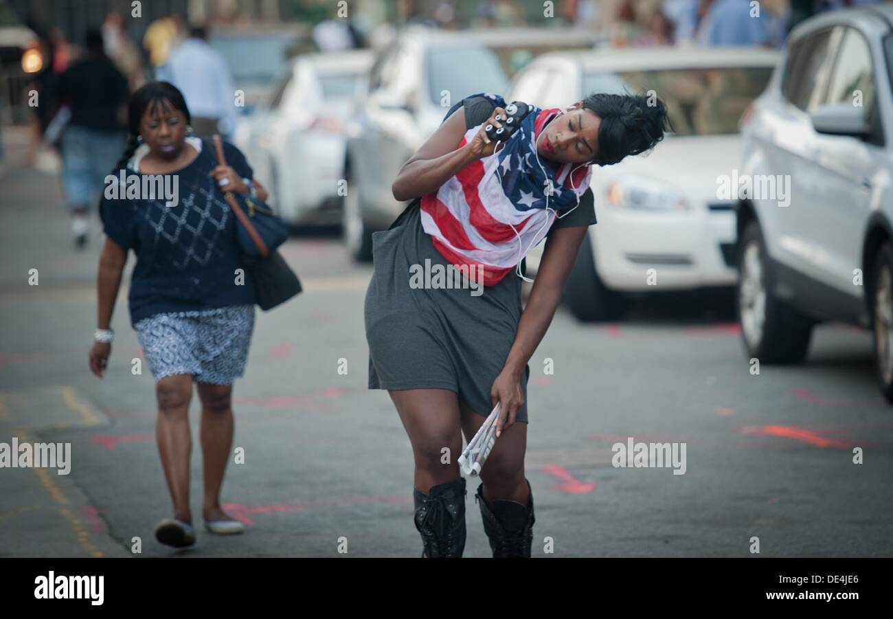Manhattan, New York, USA. 11th Sep, 2013. A pedestrian takes a photo at ...
