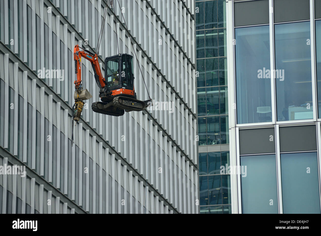 Small excavator being lowered to the ground, just outside the office ...